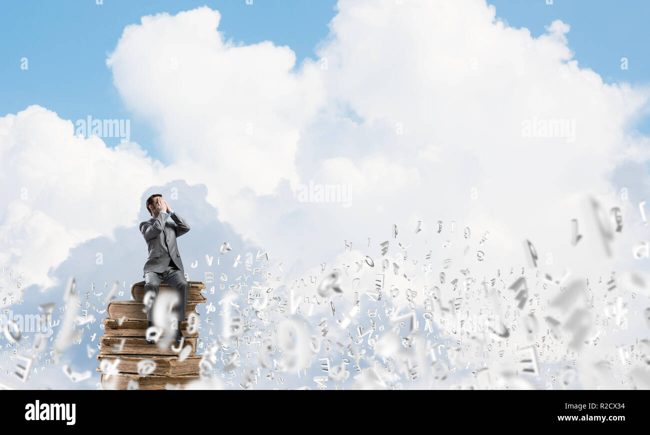 Young man floating in sky and do not want to see anything Stock Photo ...