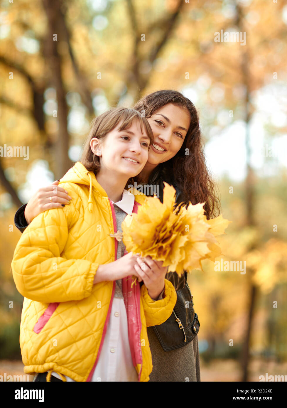 Two girls are in autumn city park Stock Photo - Alamy