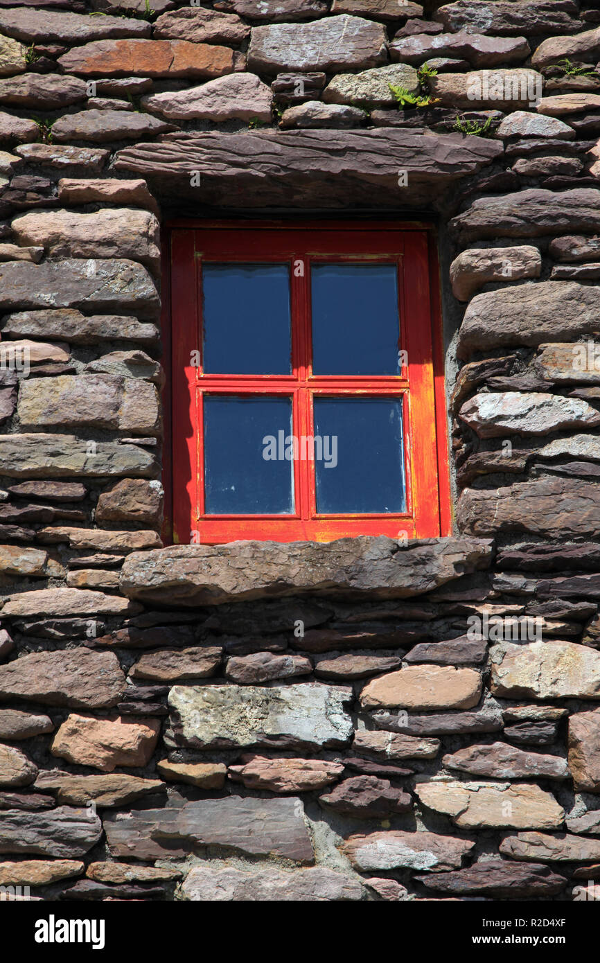 stone built housewith small wooden red painted window, wild atlantic ...