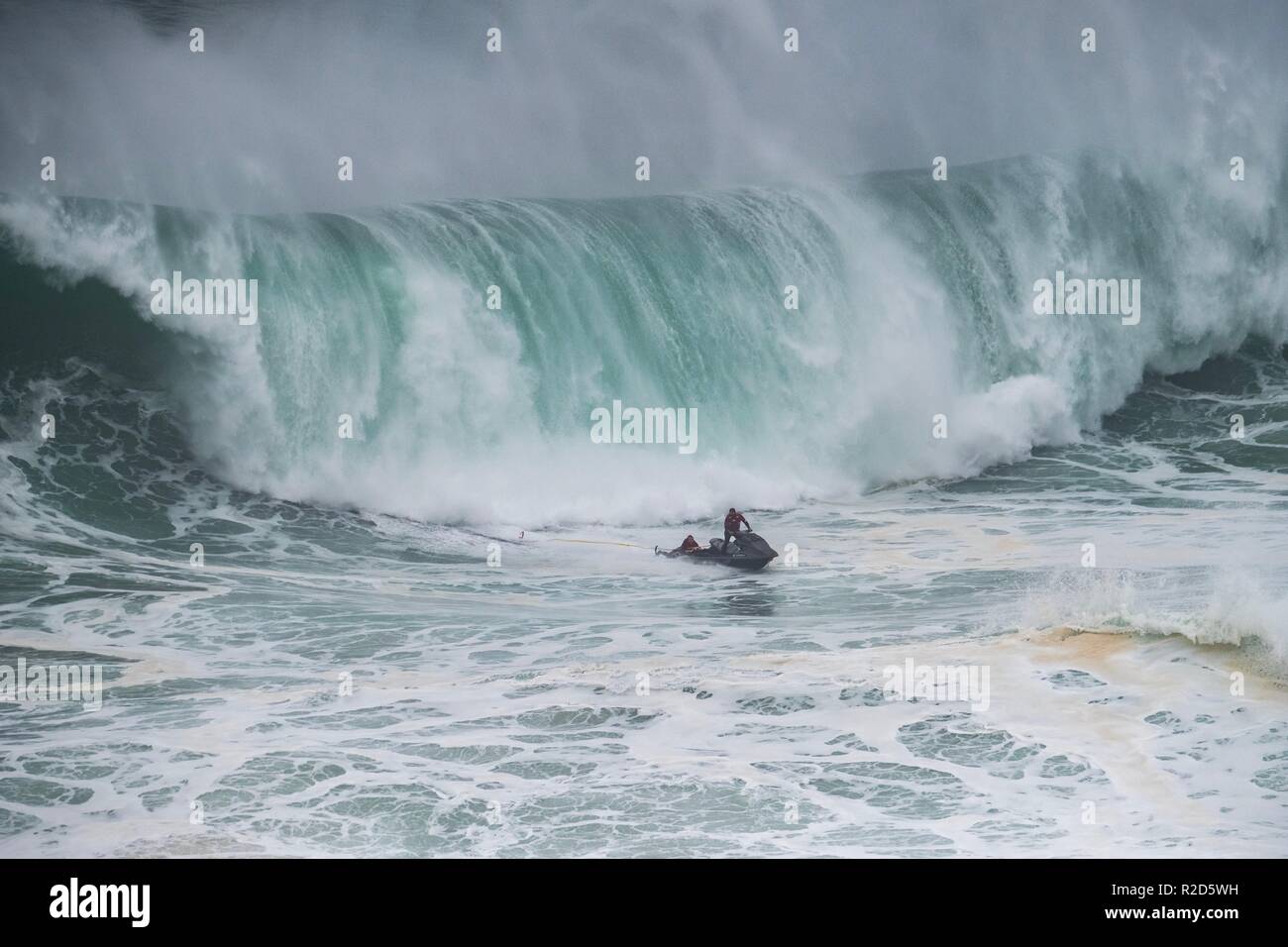 Nazare, Portugal. 18th Nov, 2018. Surfers tow in to giant waves at ...