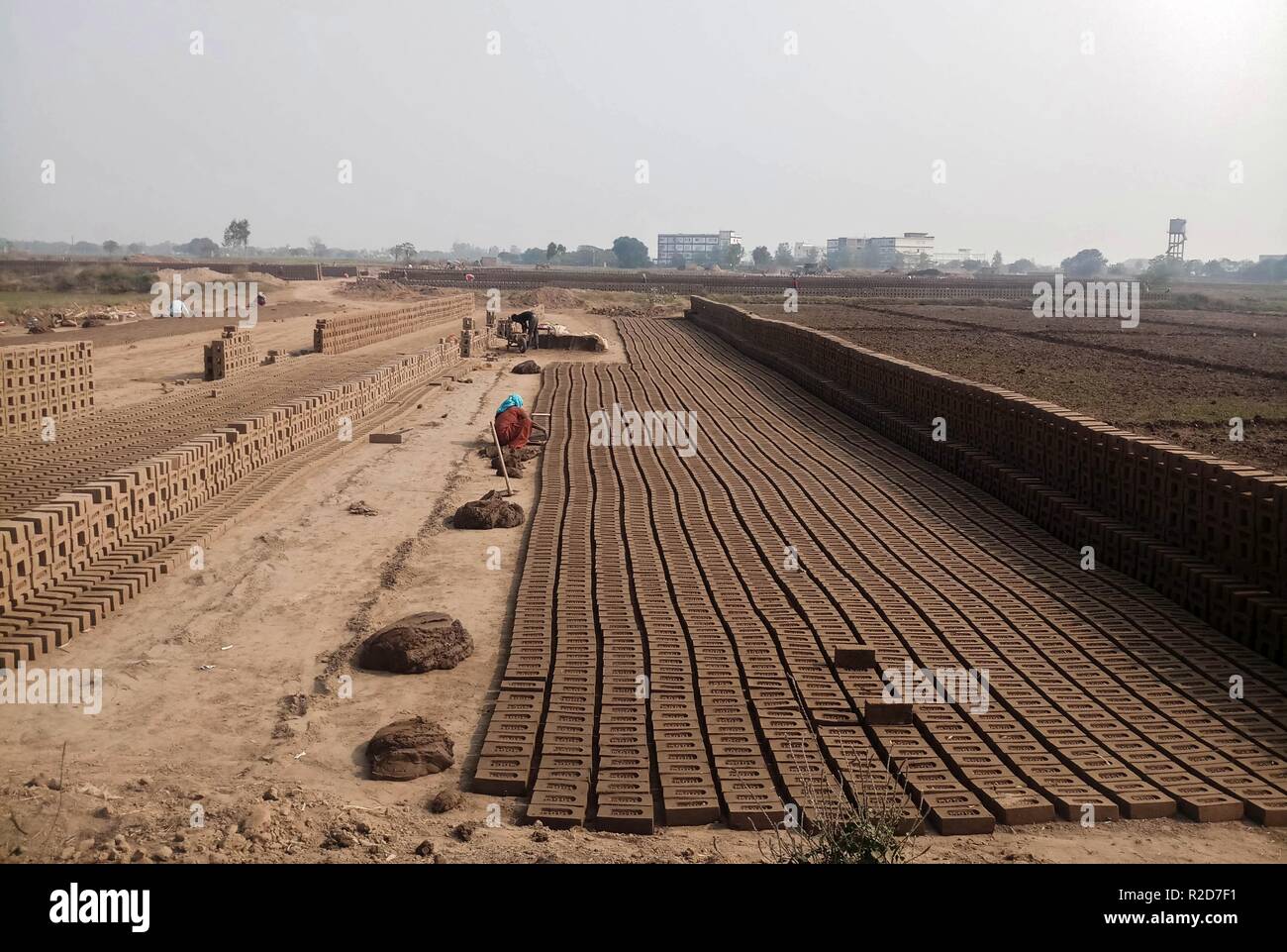 A woman labourer seen making bricks at a brick kiln factory in ...