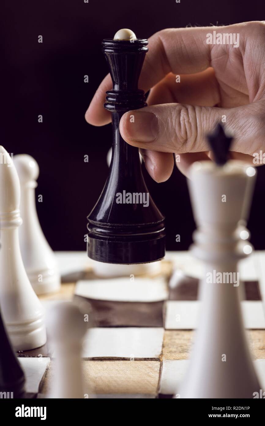 Detail of a woman's hand in a chess game Stock Photo - Alamy