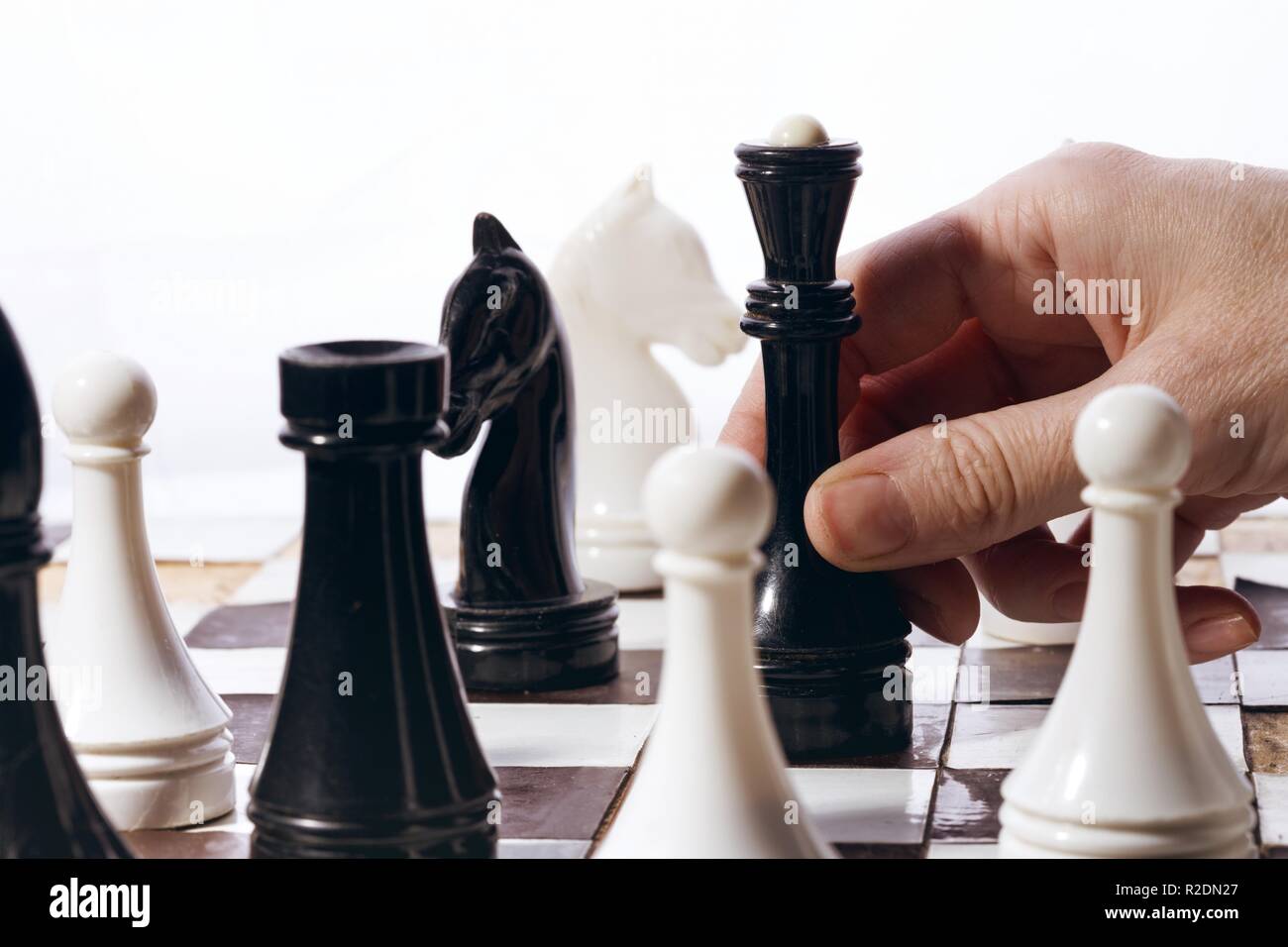 Detail of a woman's hand in a chess game Stock Photo - Alamy