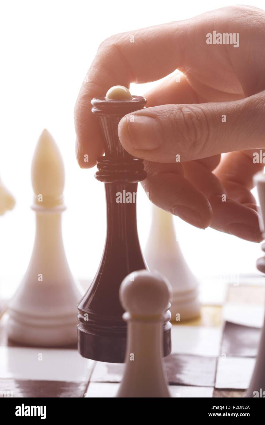 Detail of a woman's hand in a chess game Stock Photo - Alamy