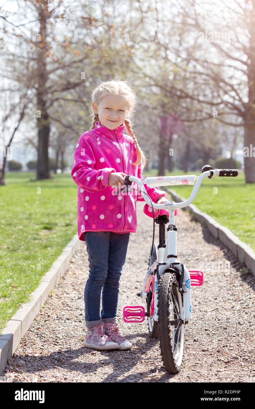 Girl with a bicycle on a walk in the park Stock Photo - Alamy