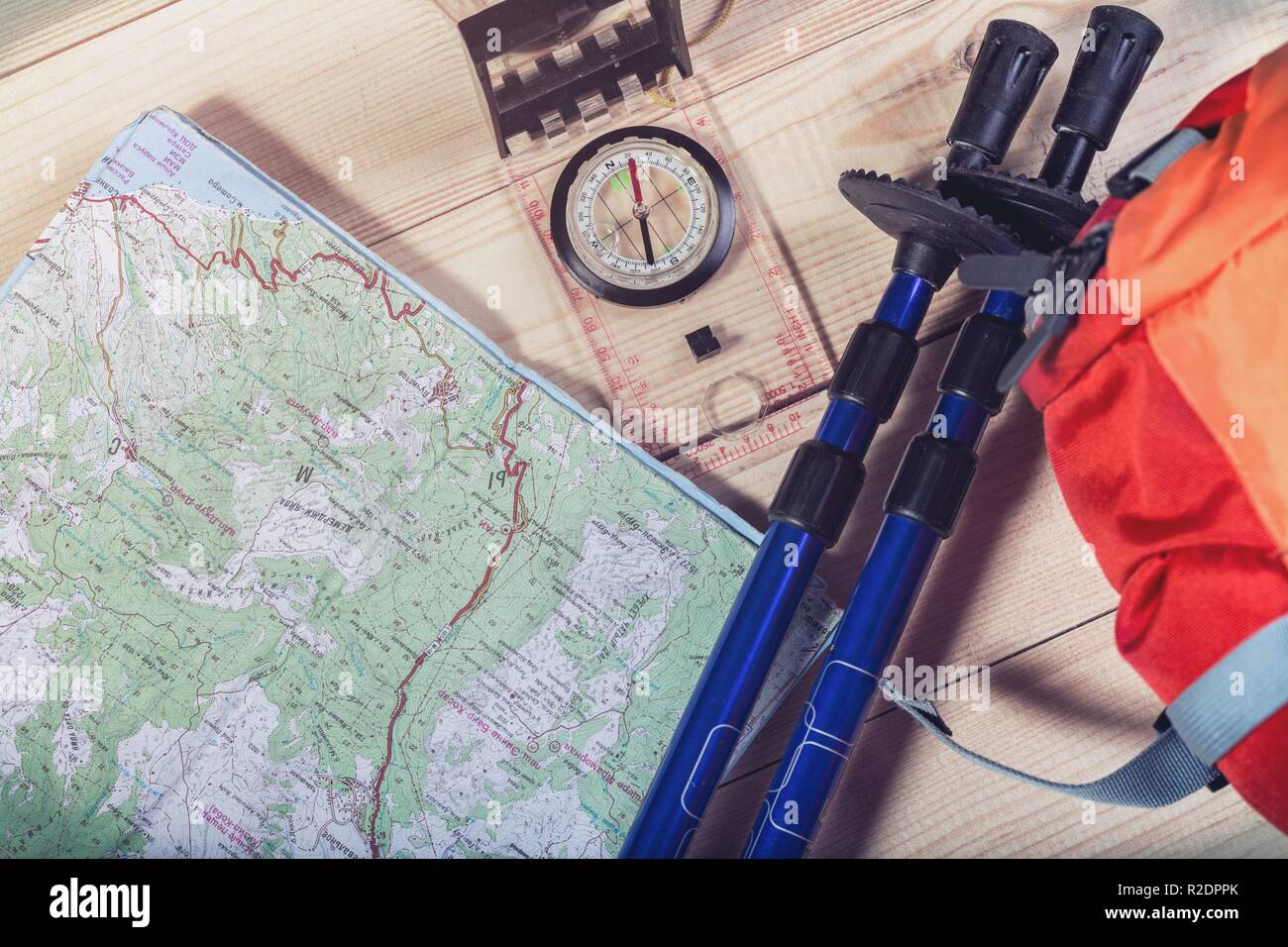 compass, map, trekking poles and backpack on a wooden background Stock ...