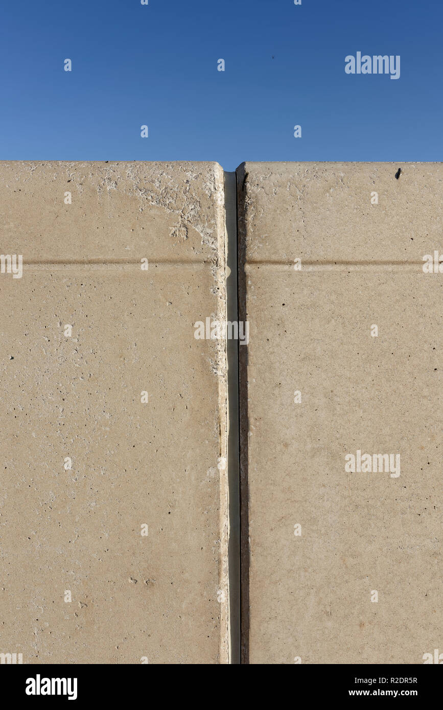 Two precast concrete panels, expansion joint and sealer, with blue sky ...