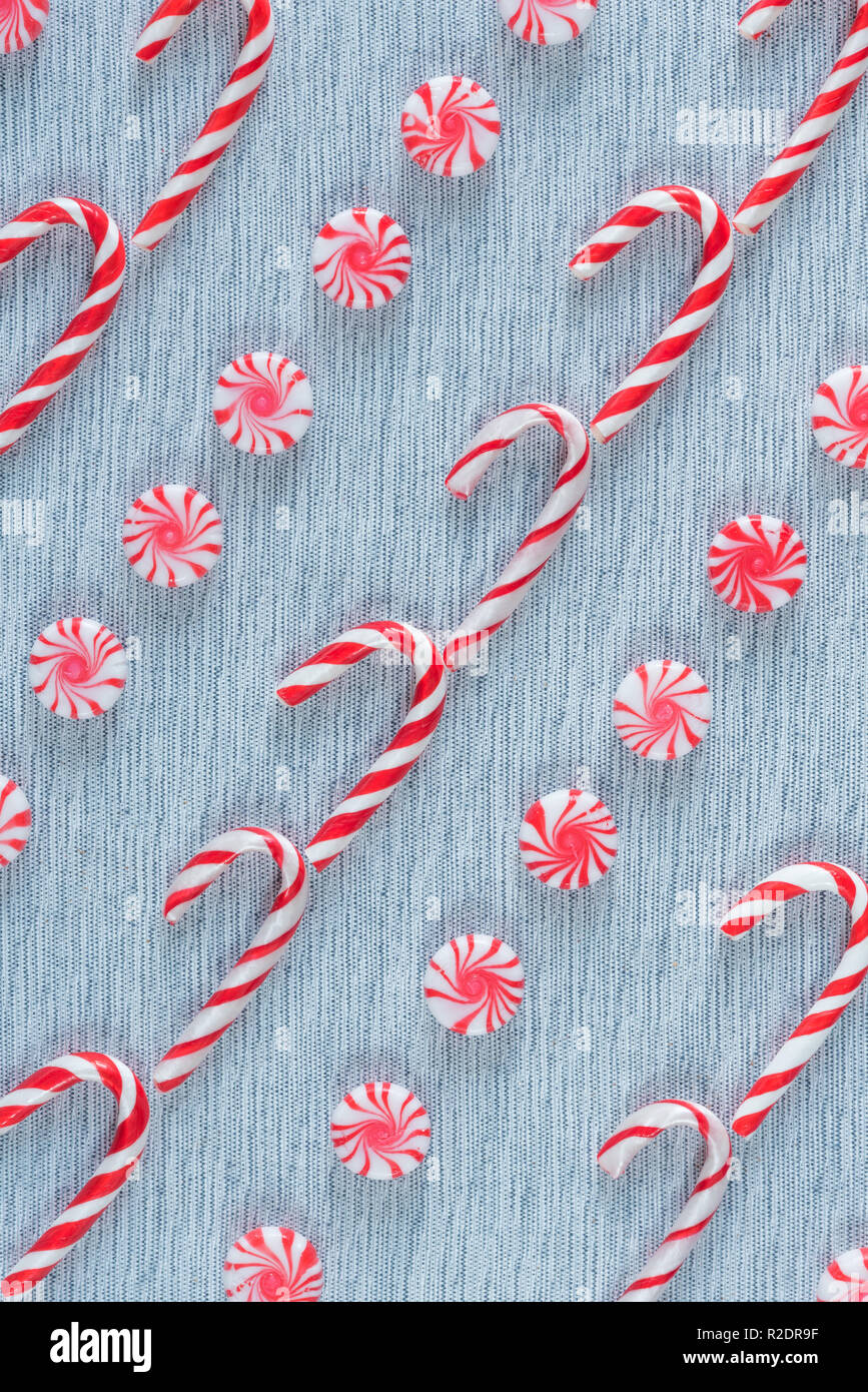 Diagonal rows of Christmas candy canes and peppermint swirl candies ...