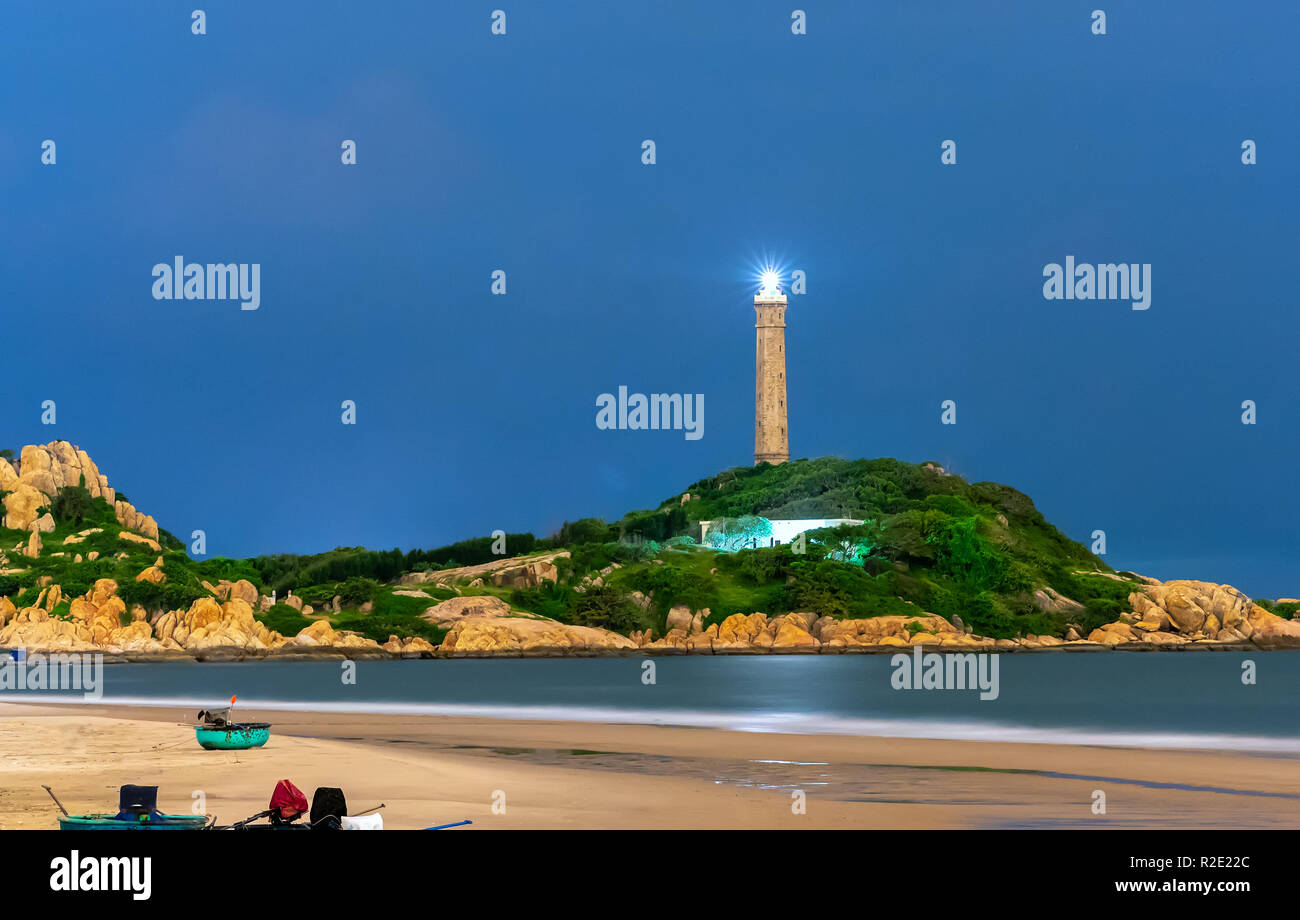 Lighthouse shines at night on the beautifully located island. This is a ...