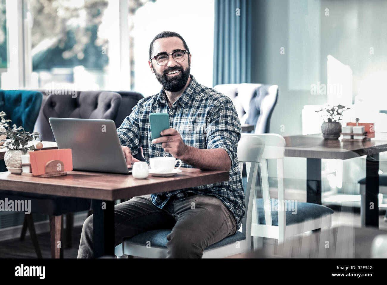 Successful businessman working remotely sitting in restaurant Stock ...