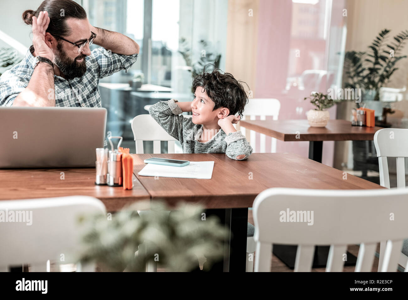Father and son having fun while waiting for their order in the ...