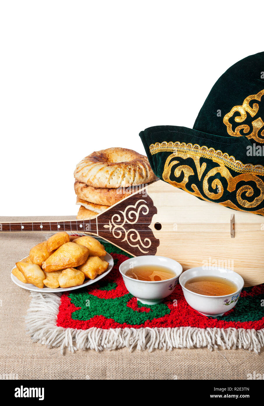 Asian dishes, tea and Dombra Kazakh instrument on the table with ...