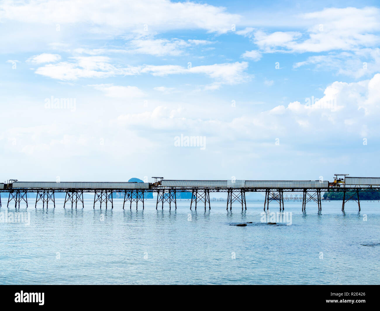 Industrial jetty for loading facility in the sea on blue sky background ...