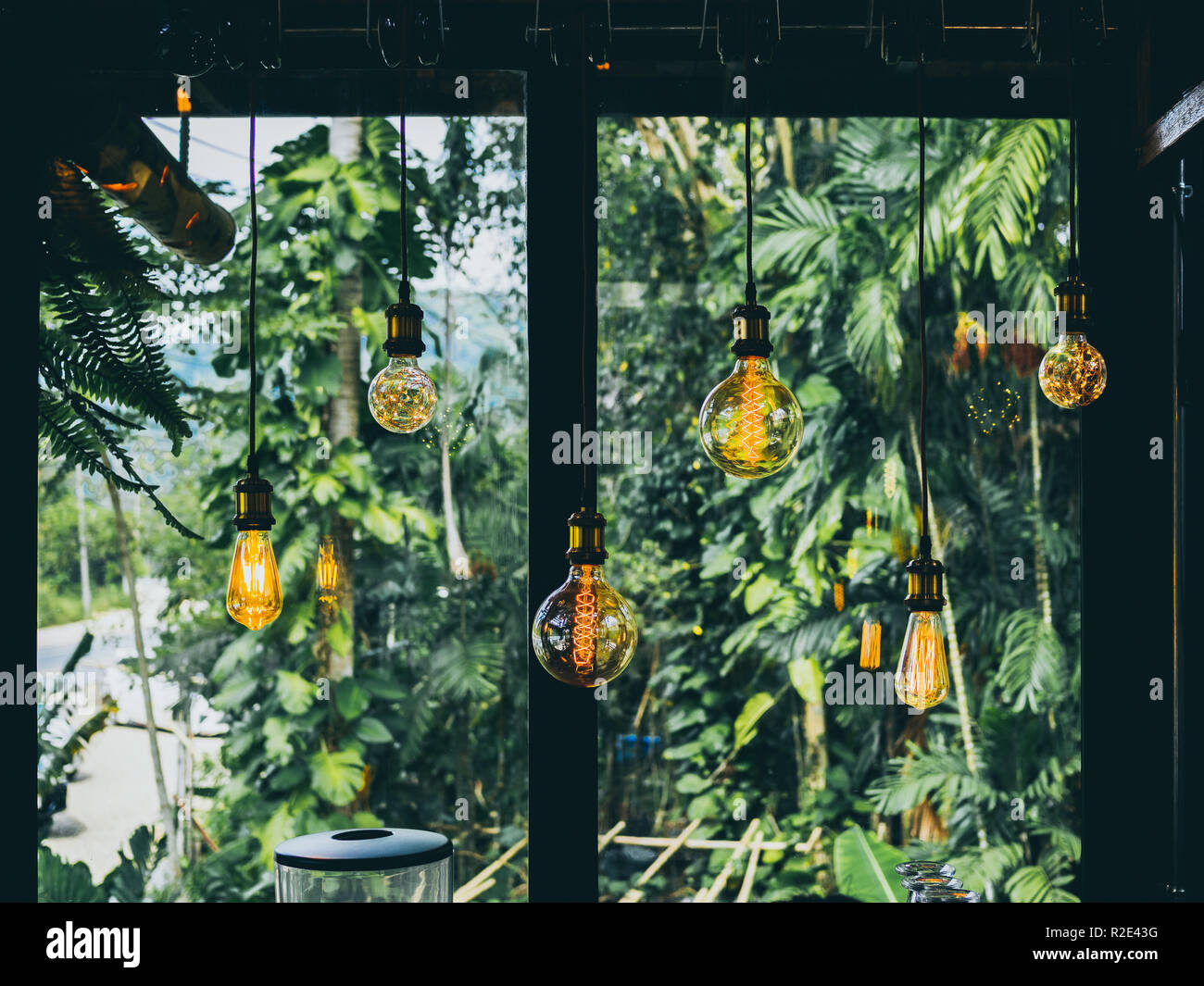 Decorative antique edison vintage style light bulbs on green garden in ...