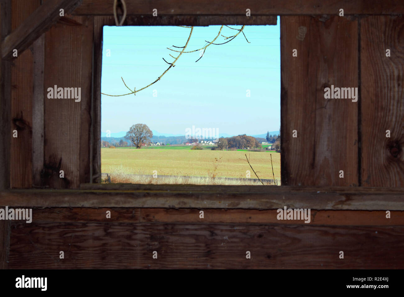 Country landscape as seen through the window of an old abandoned barn ...