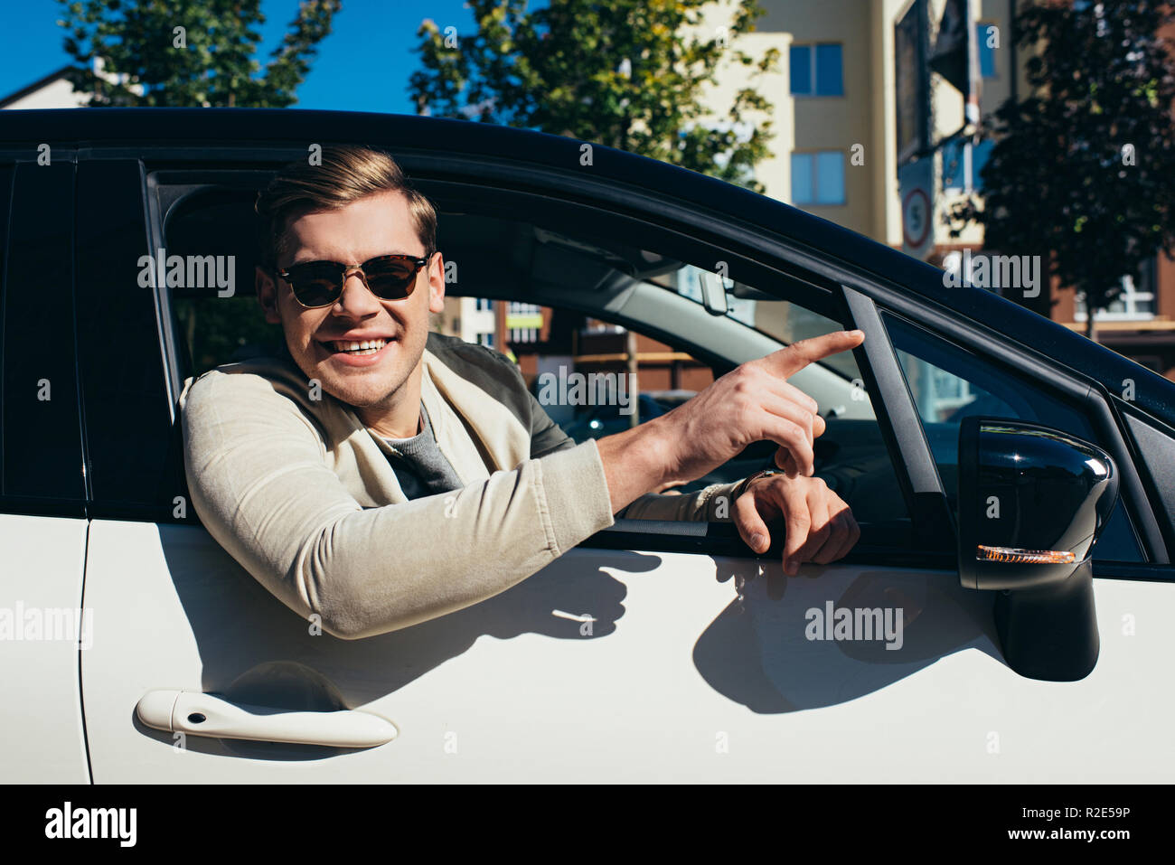 young man leaning out car window of driving automobile Stock Photo - Alamy