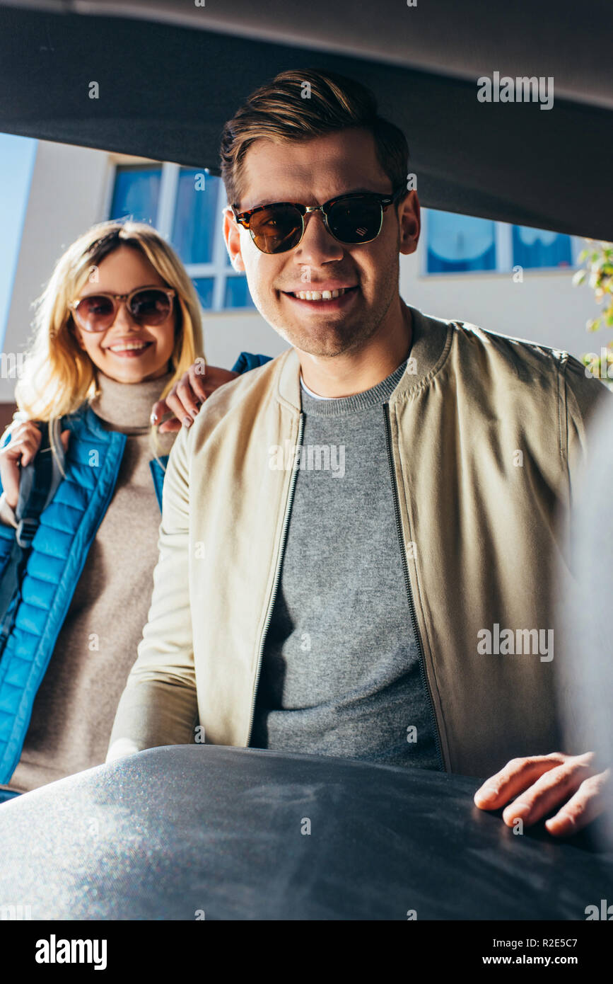 Man standing behind car hi-res stock photography and images - Alamy
