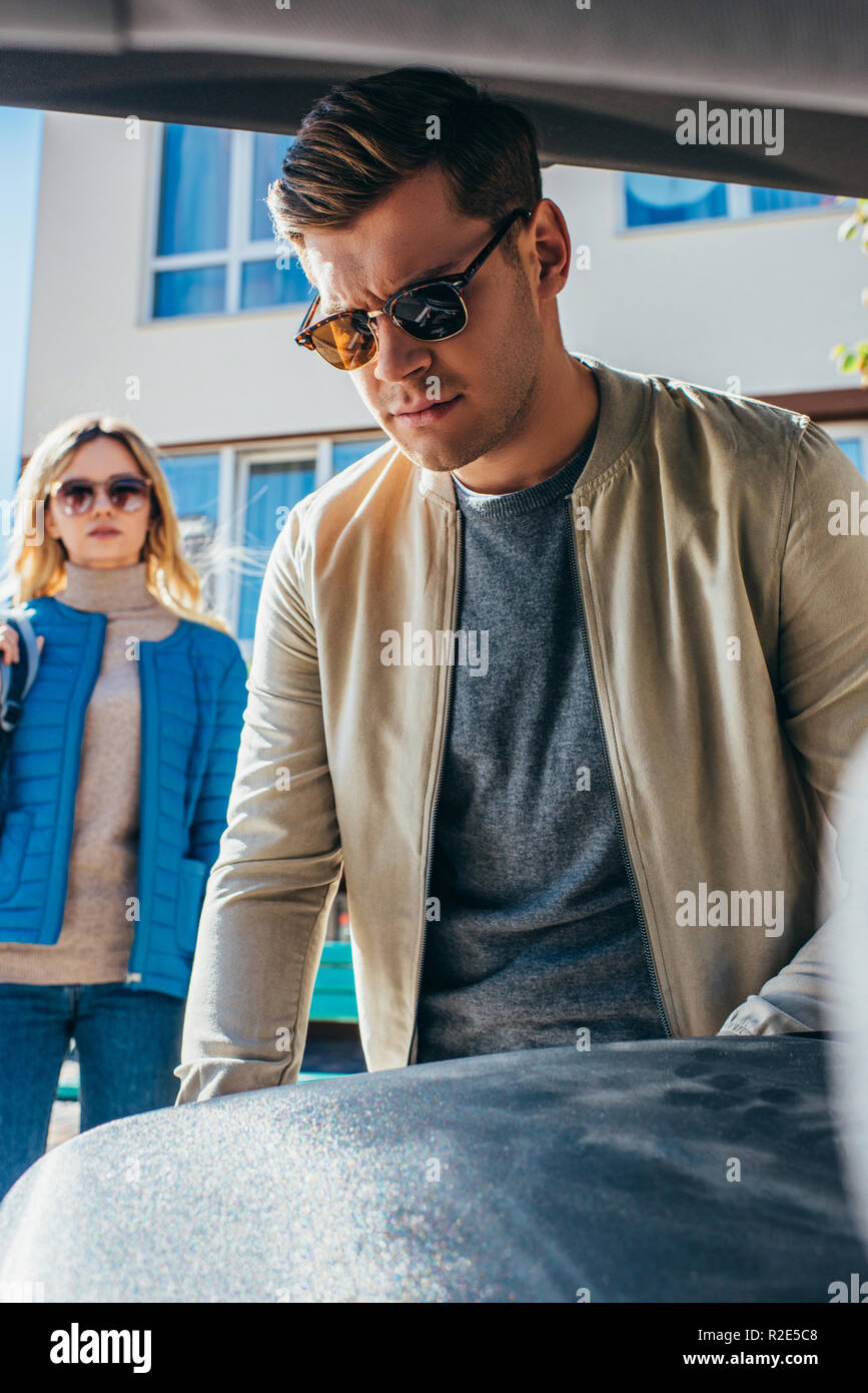 Man standing behind car hi-res stock photography and images - Alamy