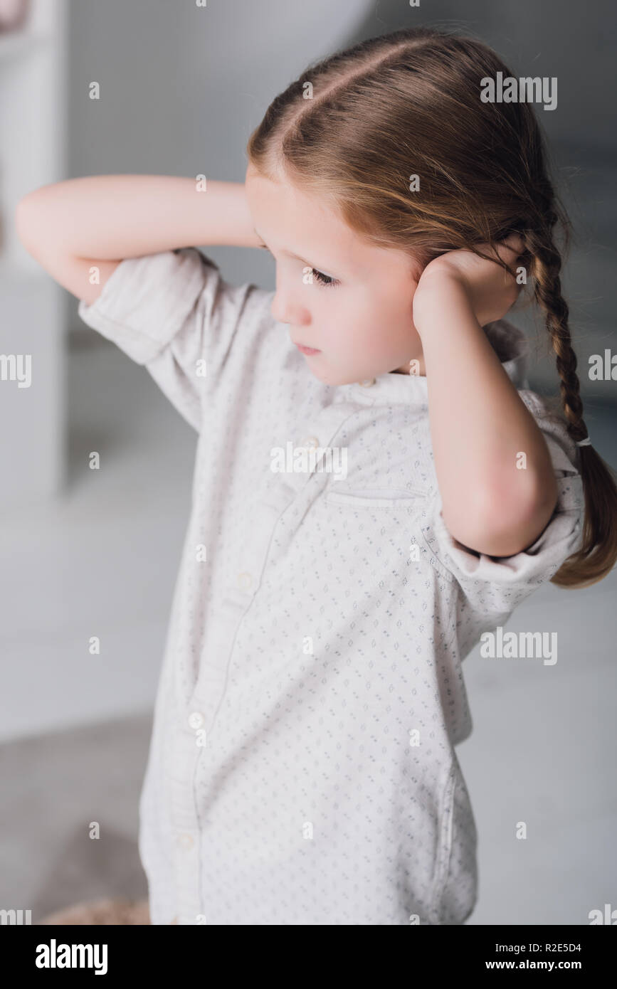 Child covering ears hi-res stock photography and images - Alamy