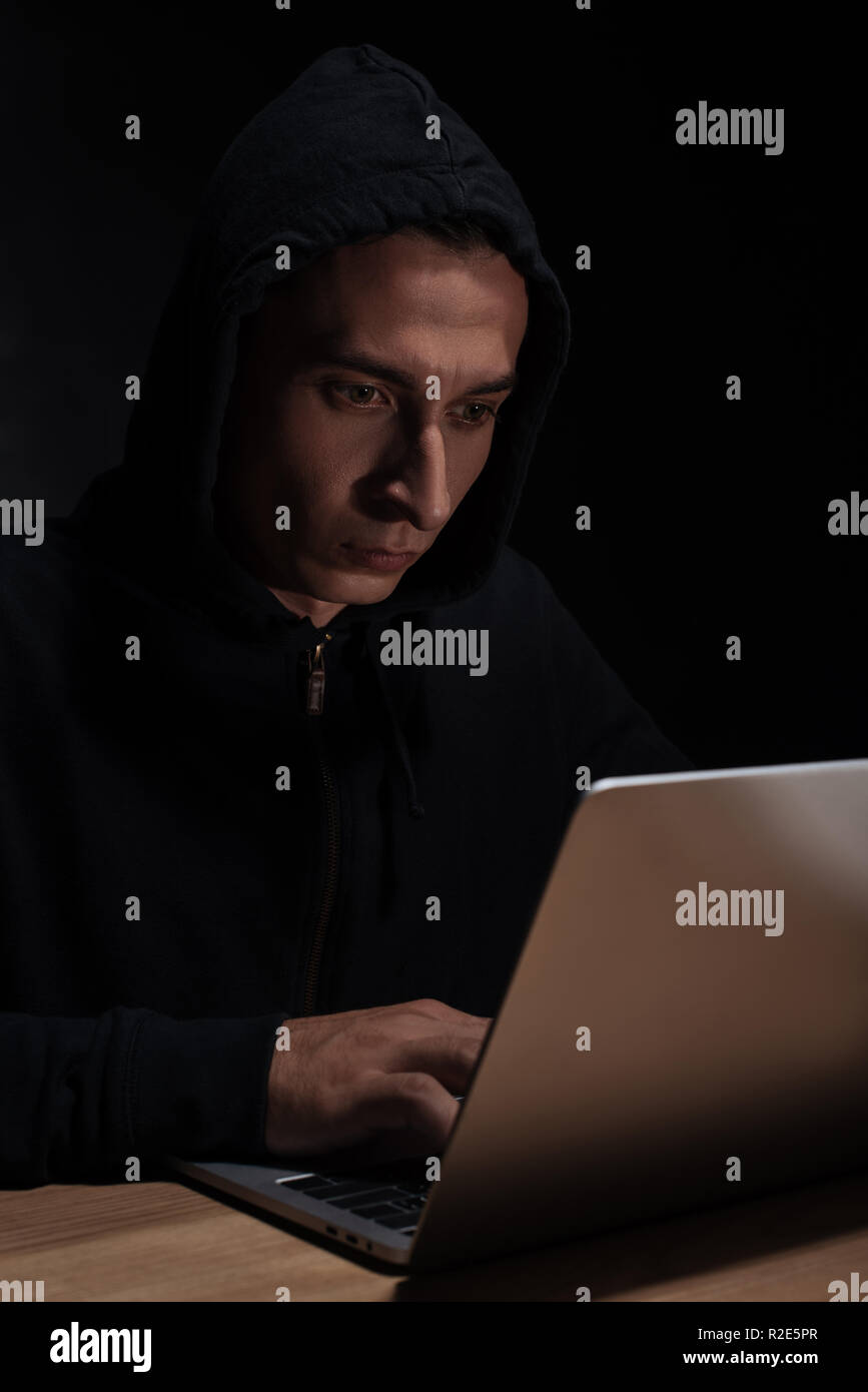 hacker in black hoodie using laptop, cuber security concept Stock Photo ...