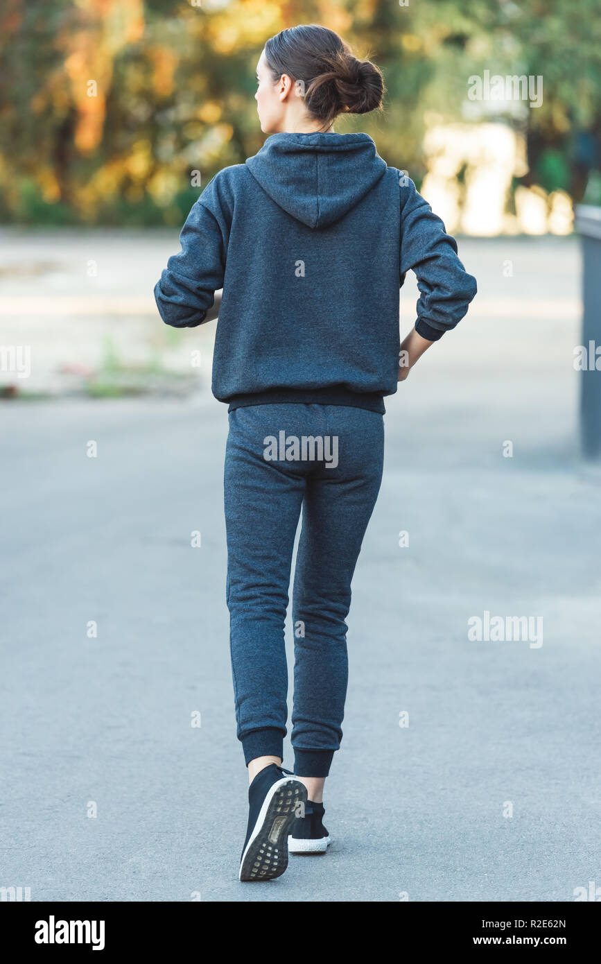 back view of active adult sportswoman jogging in sportswear Stock Photo ...