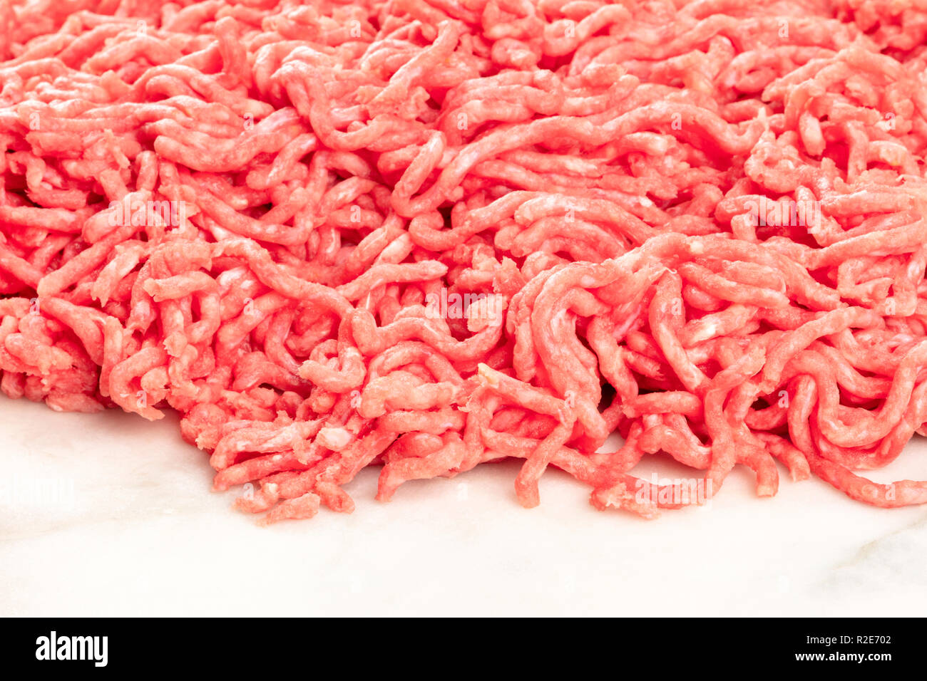 Minced meat texture on a white marble kitchen background with a place ...