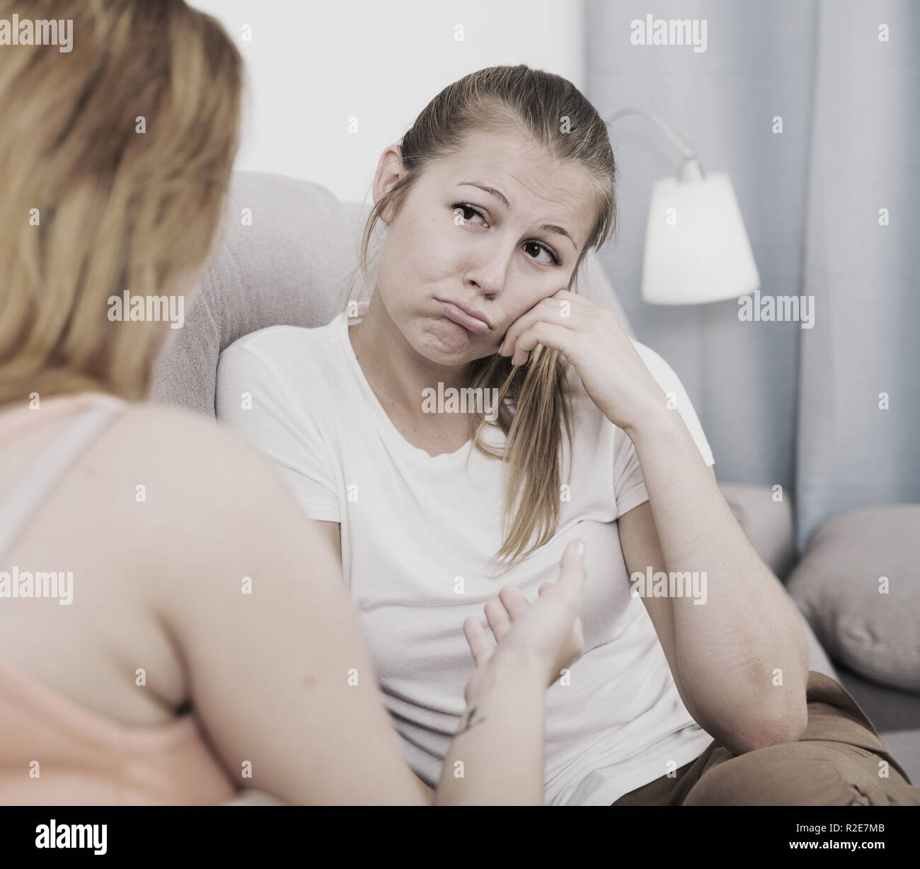 Young girl is comforting her sad girlfriend at her home Stock Photo - Alamy