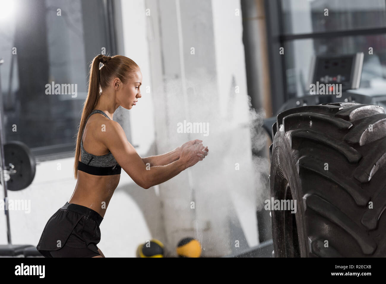 side view of attractive athletic bodybuilder applying talcum powder ...