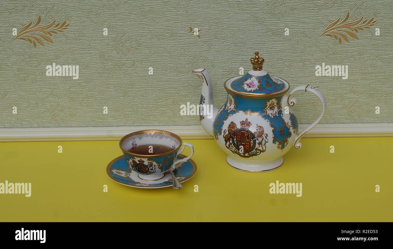 English teacup with saucer, spoon and teapot, fine bone china porcelain ...