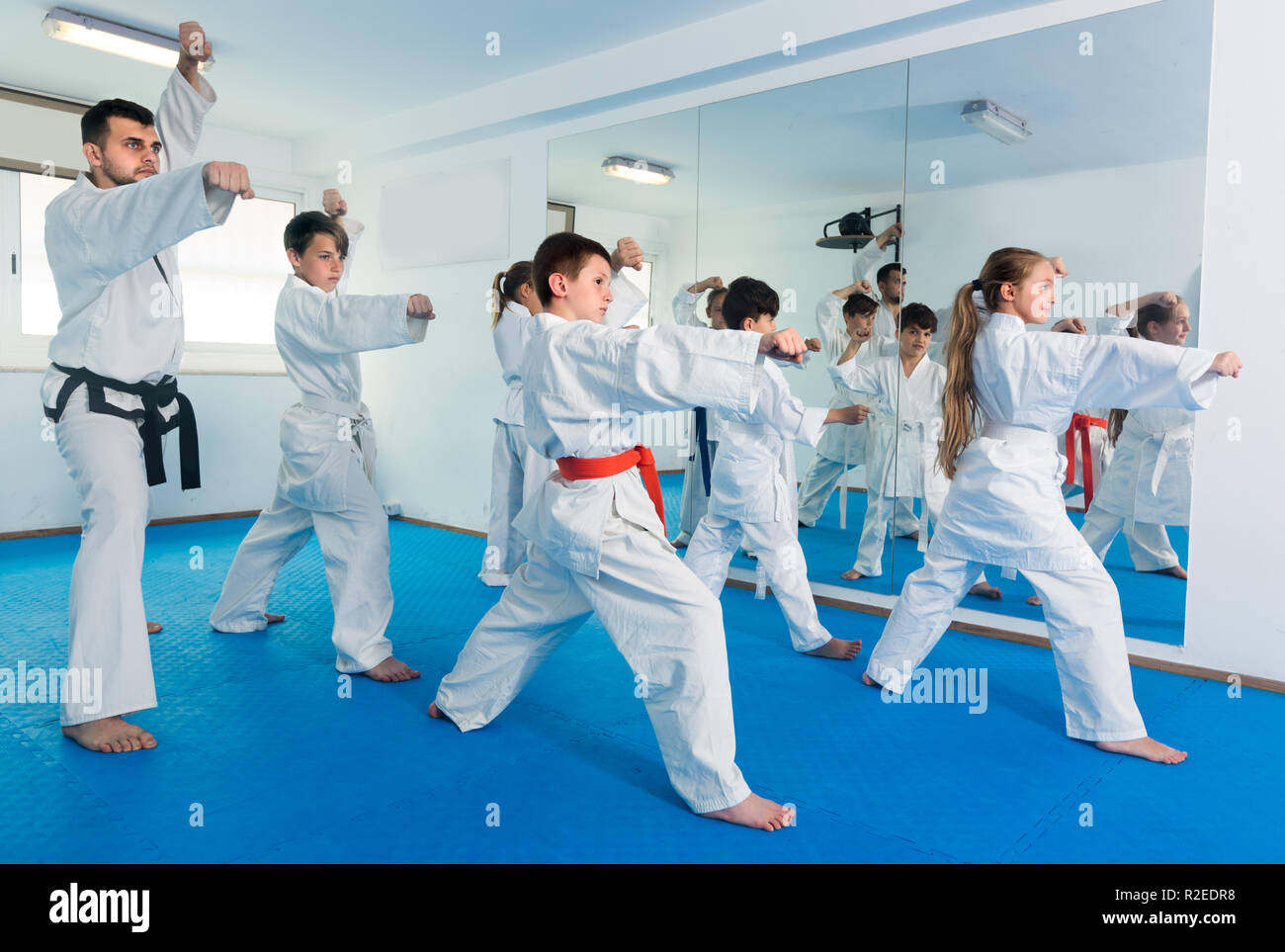 Young coach is training young teenagers in karate class Stock Photo - Alamy