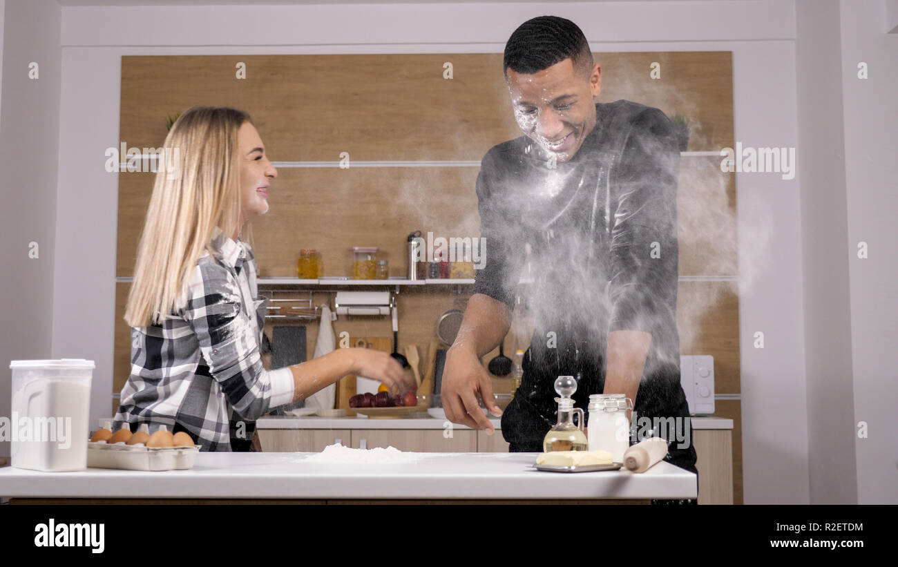 Beautiful couple having fun while cooking their romantic dinner. Strong ...