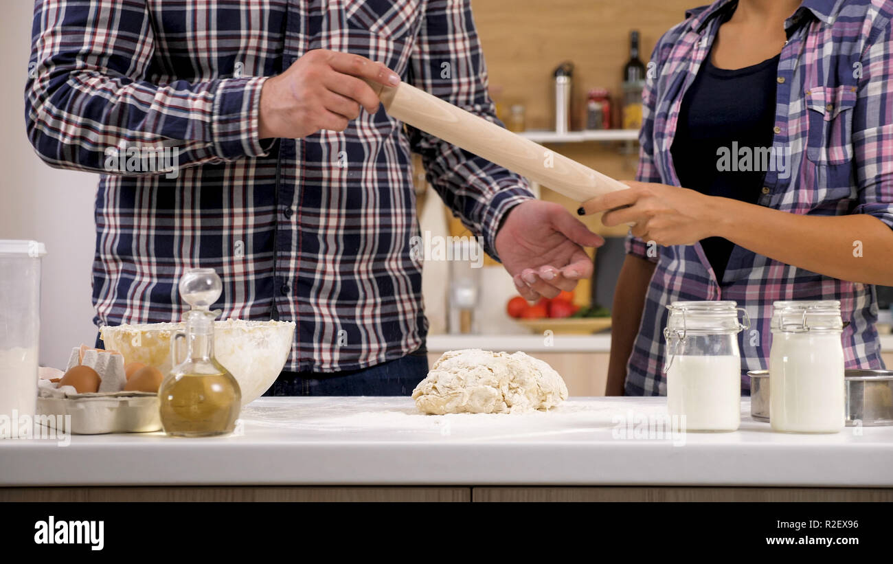 Young man baking something sweet for him and his wife. Time for sweet ...