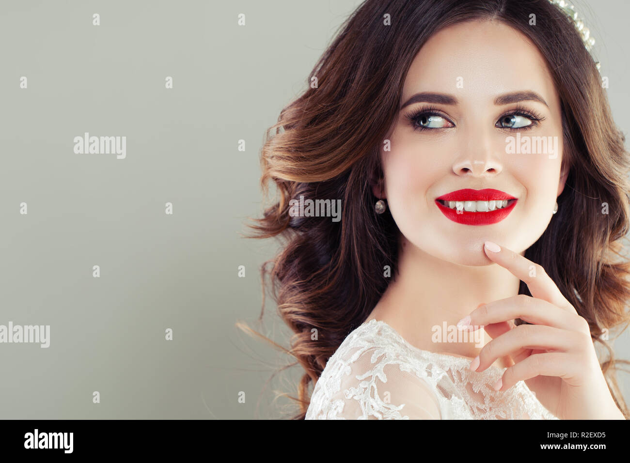 Beautiful young woman with makeup and wavy hairstyle portrait. Happy ...