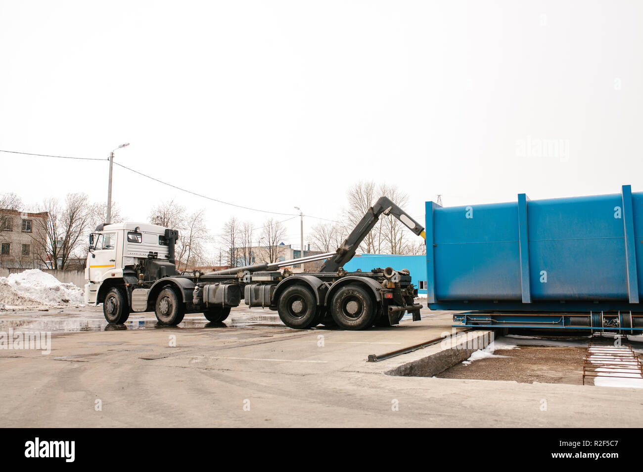 A special heavy machine loads a container with sorted waste at the ...