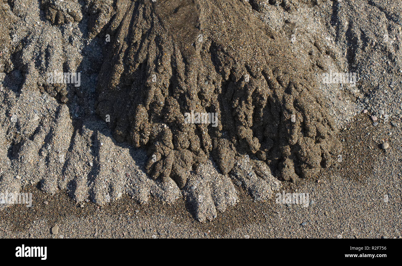 Sand forming patterns on beach from stream outlet. North Devon, England ...