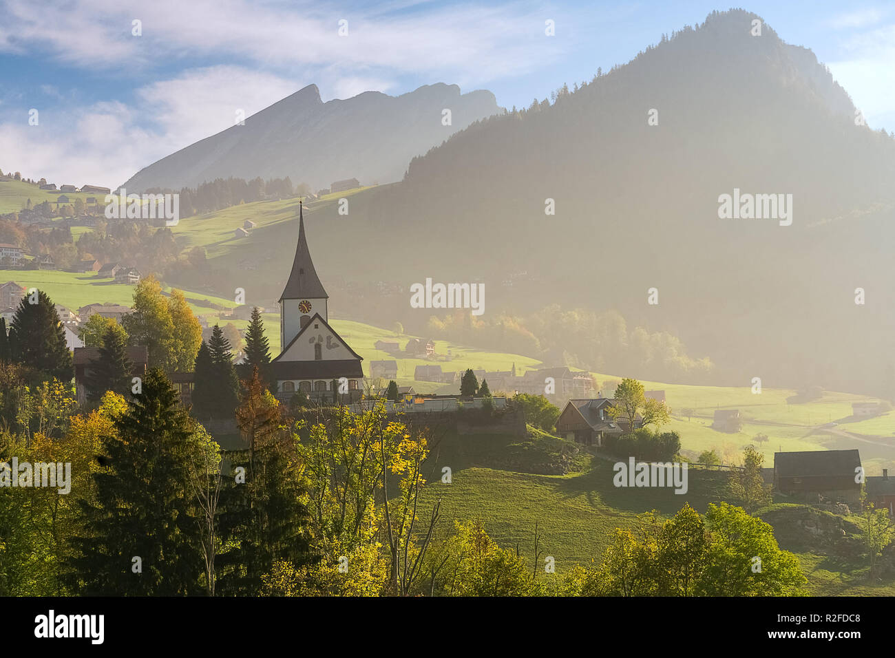 Alpine mountain scenery with church in a small country, among meadows ...