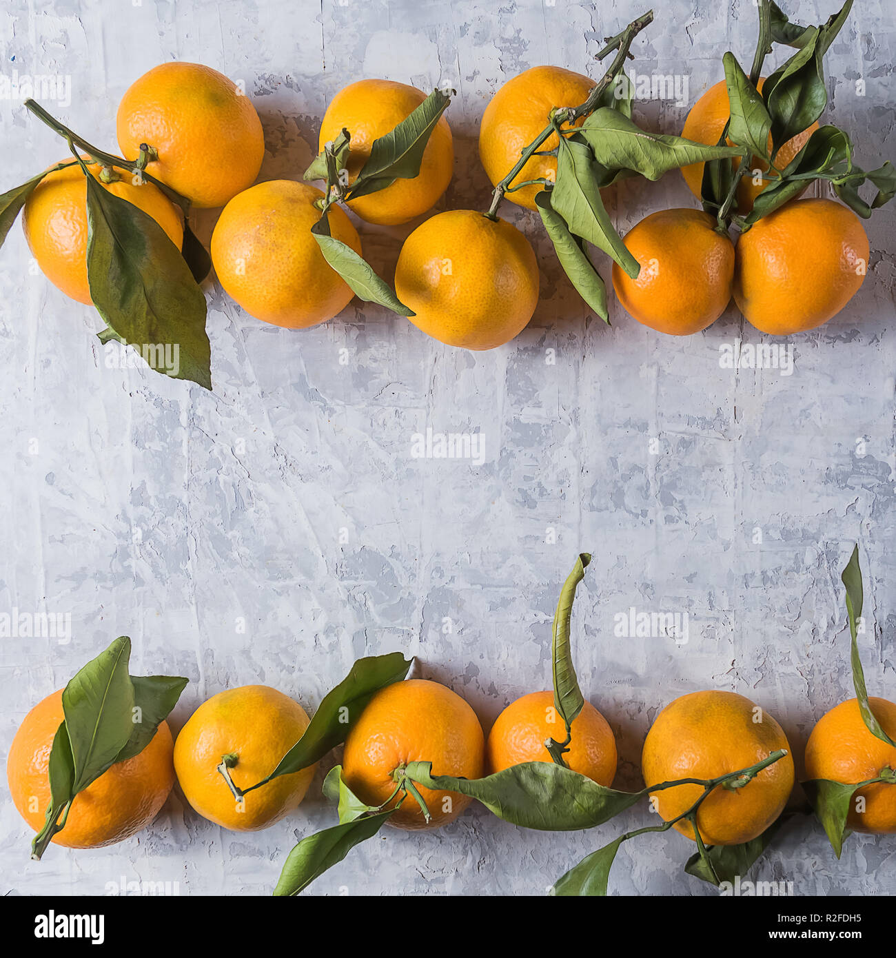 Flat lay view of Orange ripe mandarin layout fruit with green leaves ...