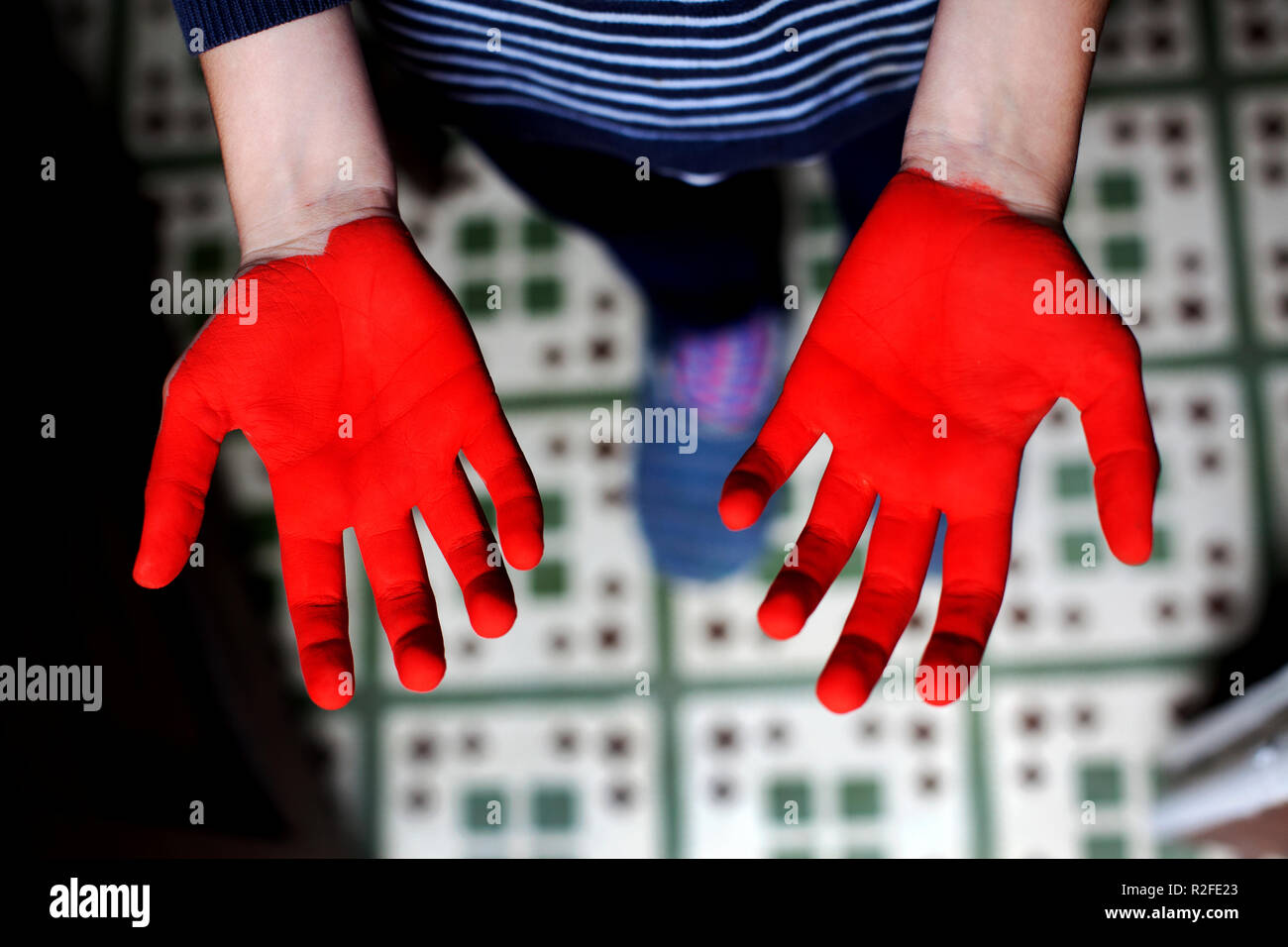 Boy with hands painted red Stock Photo - Alamy