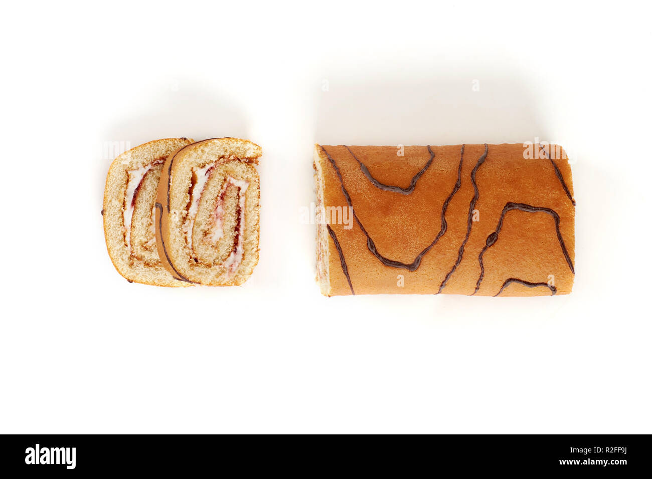 Biscuit roll cut into pieces, on a white background Stock Photo - Alamy