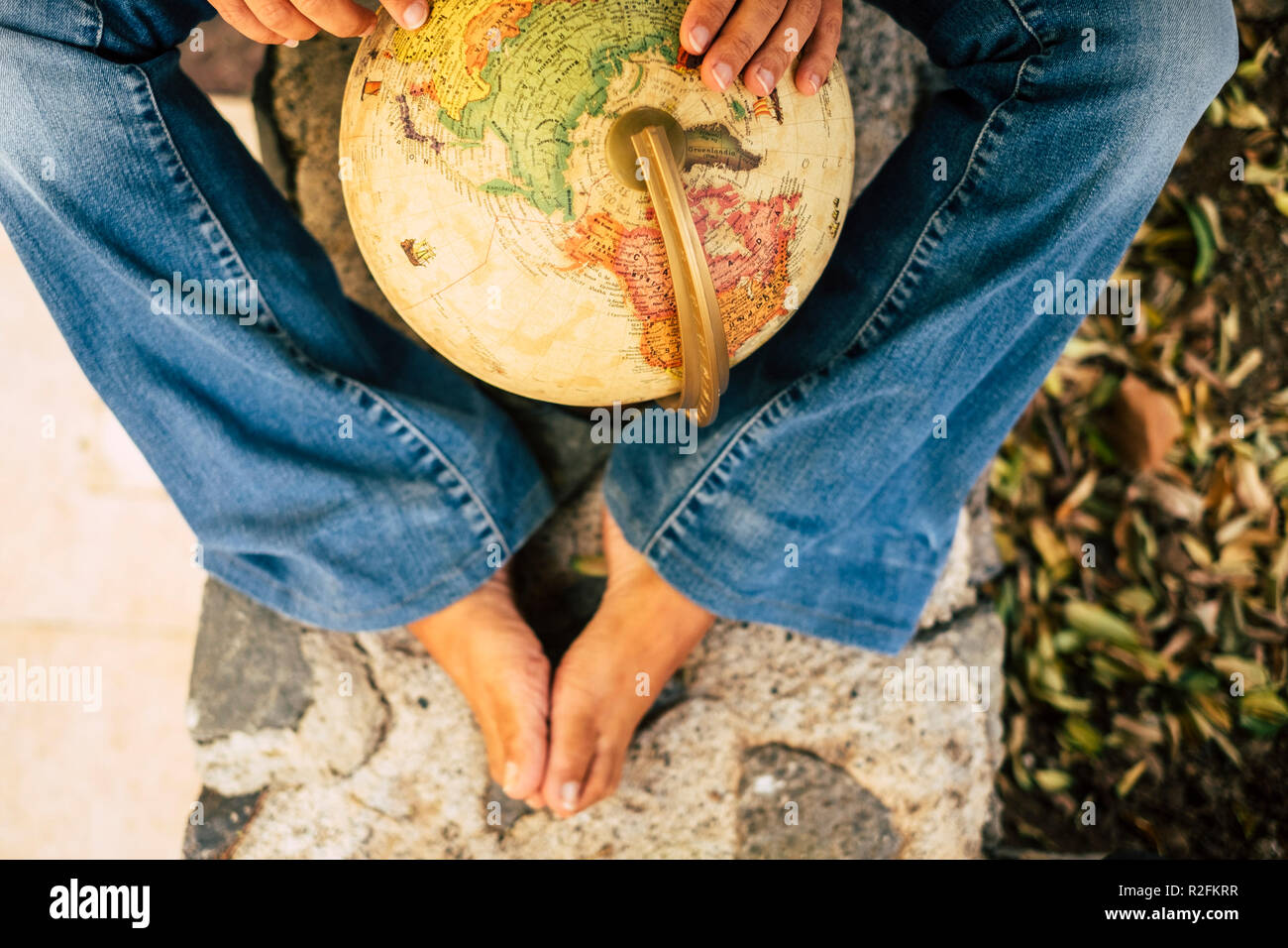 traveler caucasian legs and hands with a earth globe sphere in the ...