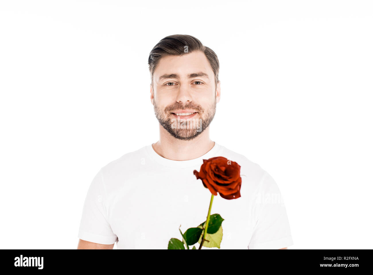 Handsome smiling young adult man with red rose isolated on white Stock ...