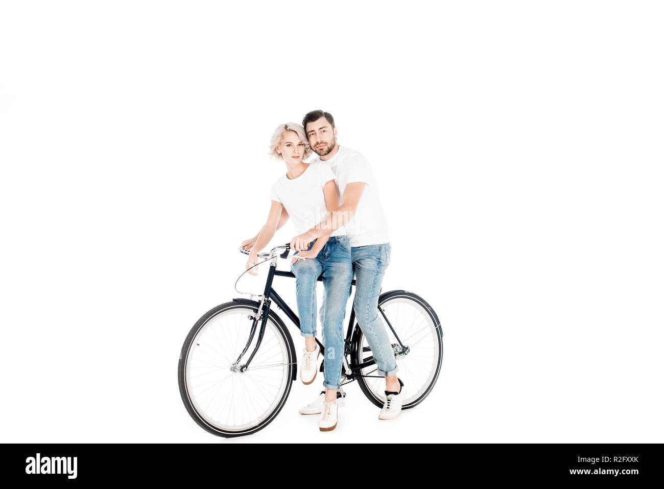 Fantastic couple hugging while riding bicycle together isolated on ...