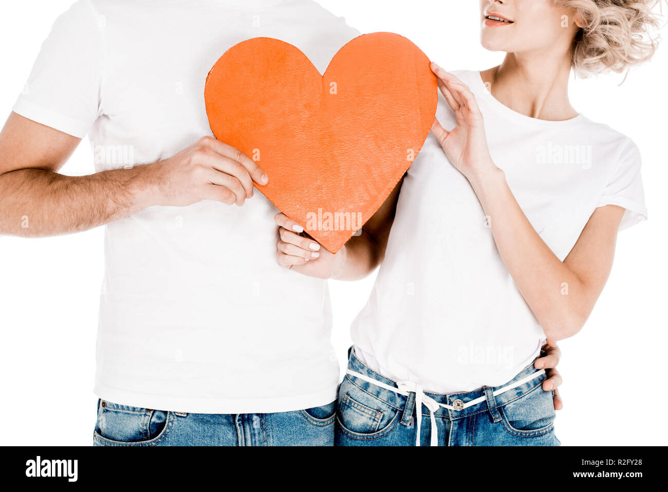 Partial view of attractive couple holding signs love isolated on white ...