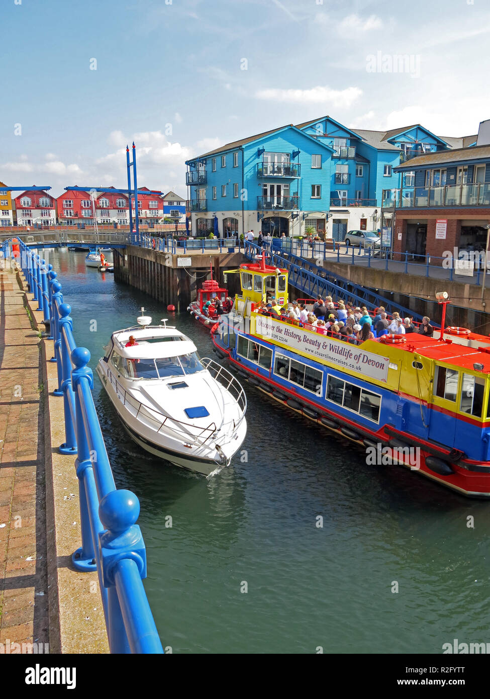 A colourful pleasure boat in the entrance to the old dock in Exmouth ...