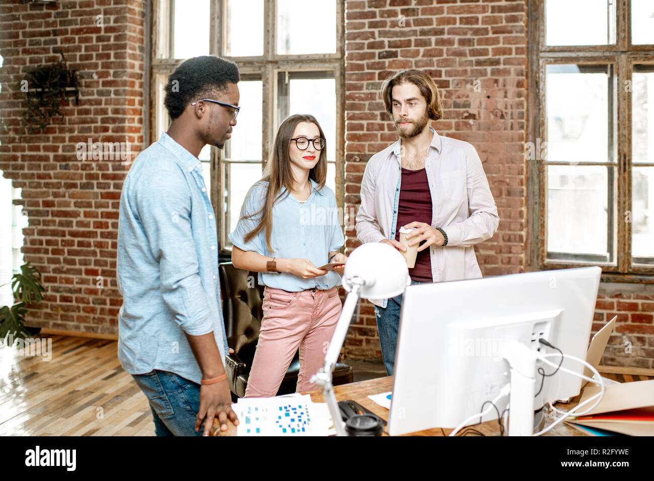 Group of a young multi ethnicity coworkers dressed casually talking ...