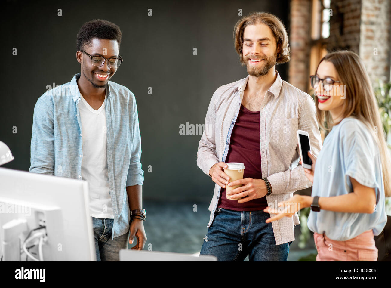 Group of a young multi ethnicity coworkers dressed casually talking ...