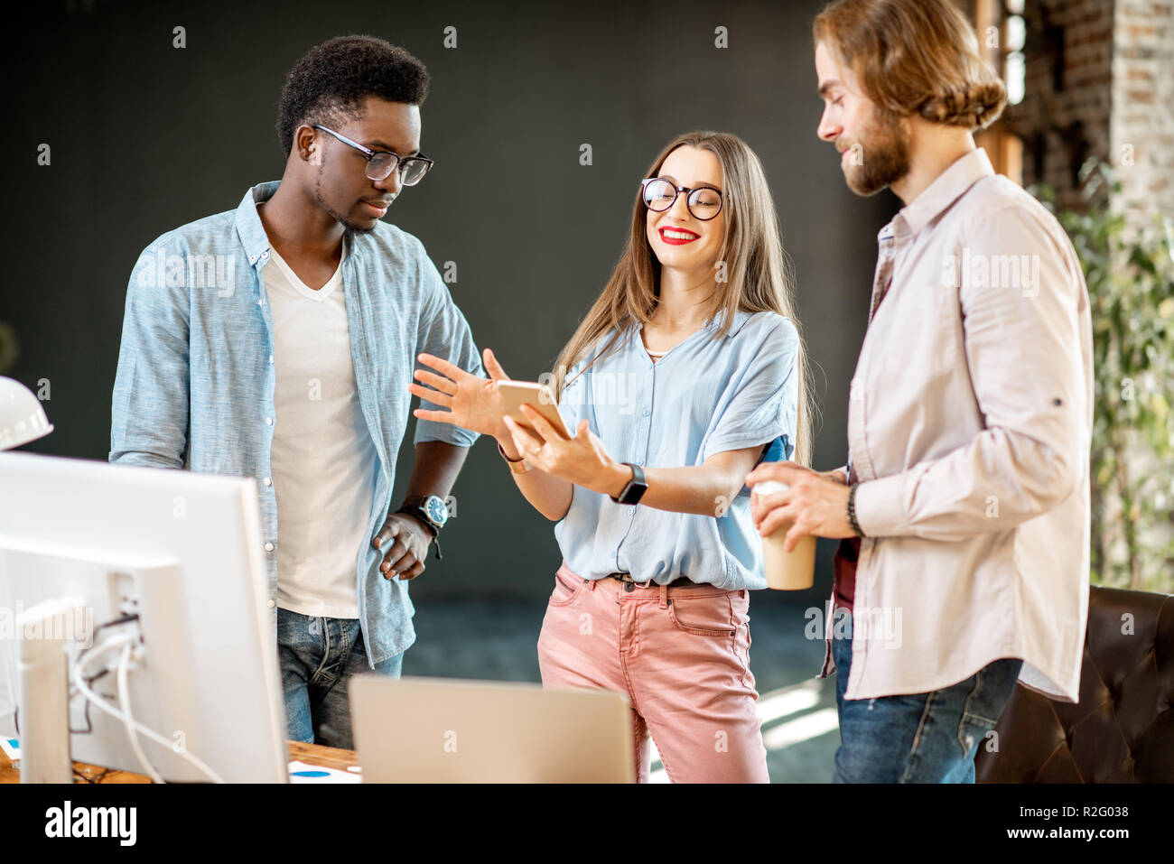 Group of a young multi ethnicity coworkers dressed casually talking ...