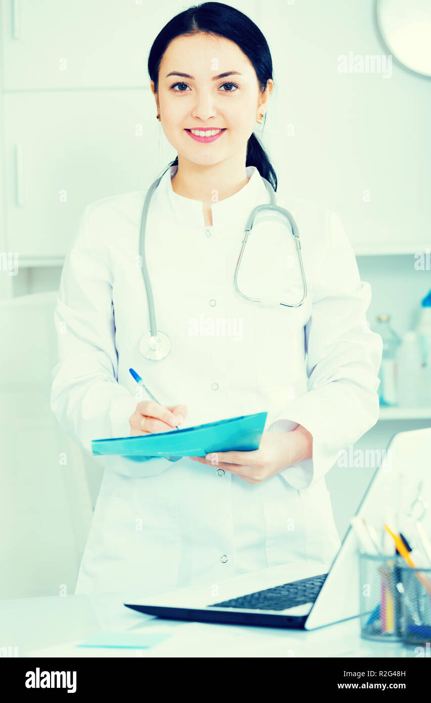 Female doctor having a productive day helping in her office Stock Photo ...