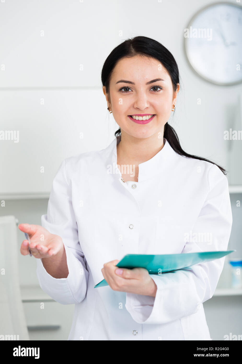 Female nurse assisting in making appointment at reception Stock Photo ...