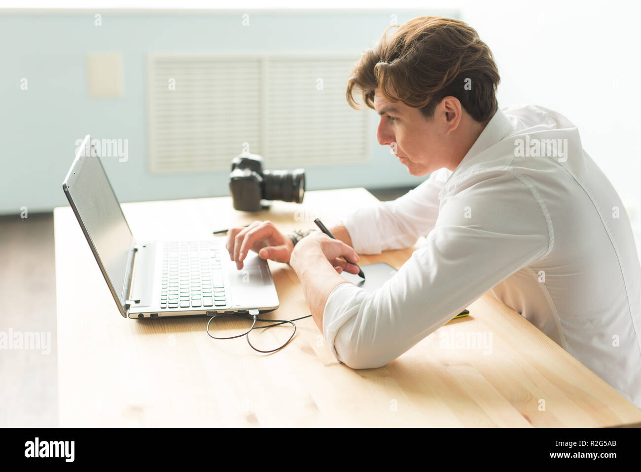 Business, technology, people concept - handsome man working with ...